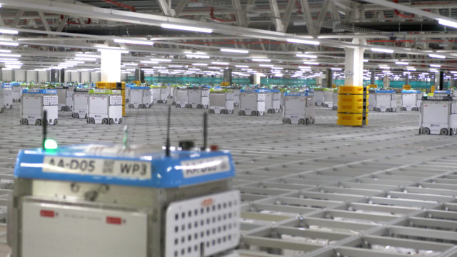 See the Ocado robots whizz around their automated supermarket warehouse ...