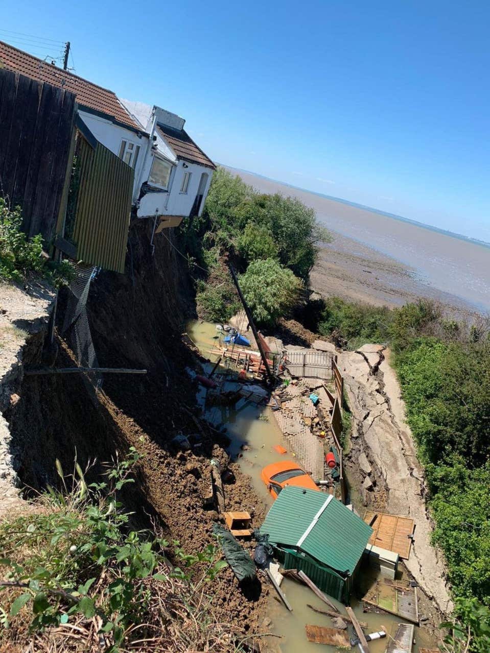 House that had been left teetering over edge after cliff collapse falls ...