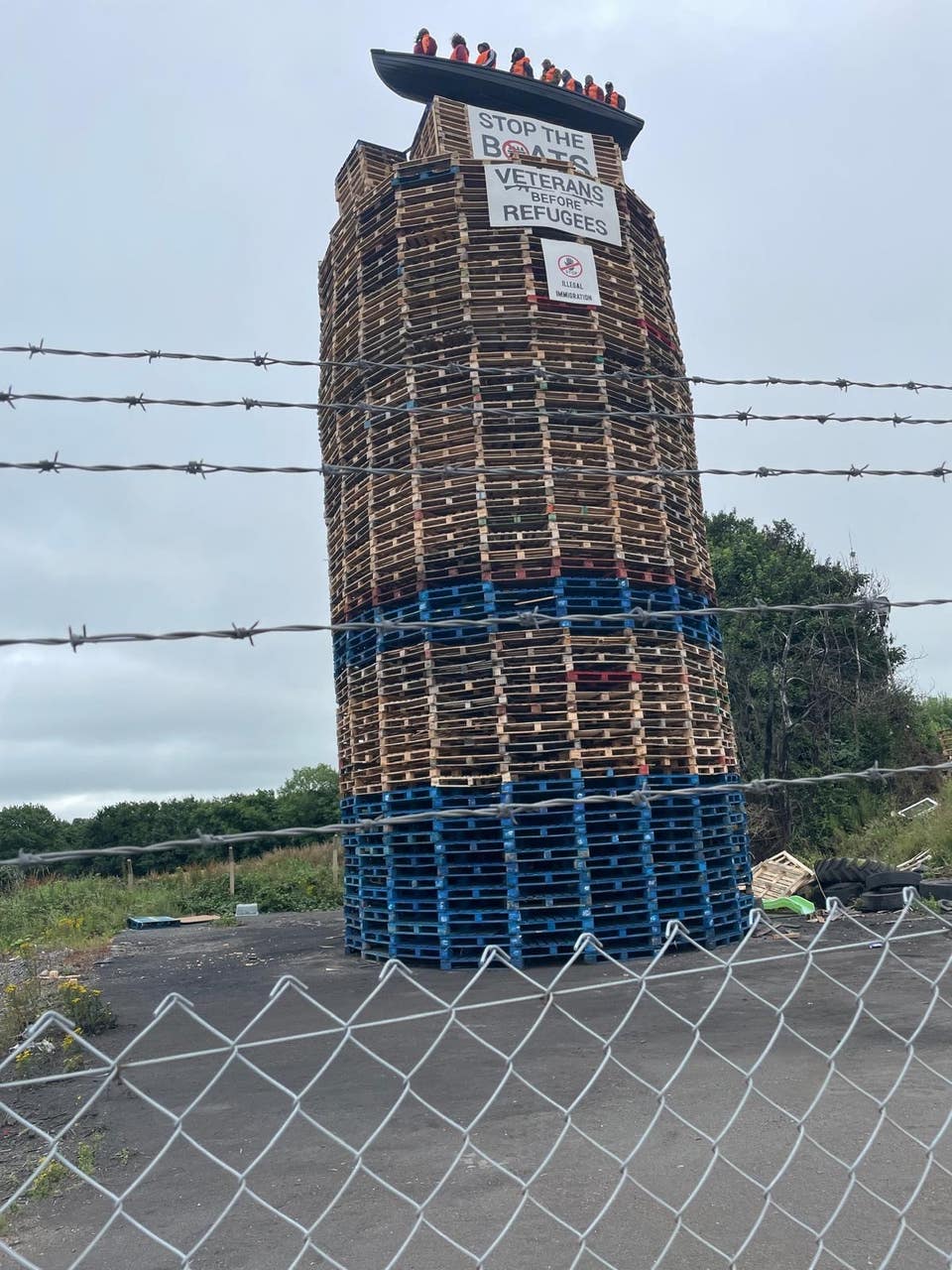 Calls for removal of migrant effigies in boat placed on loyalist ...