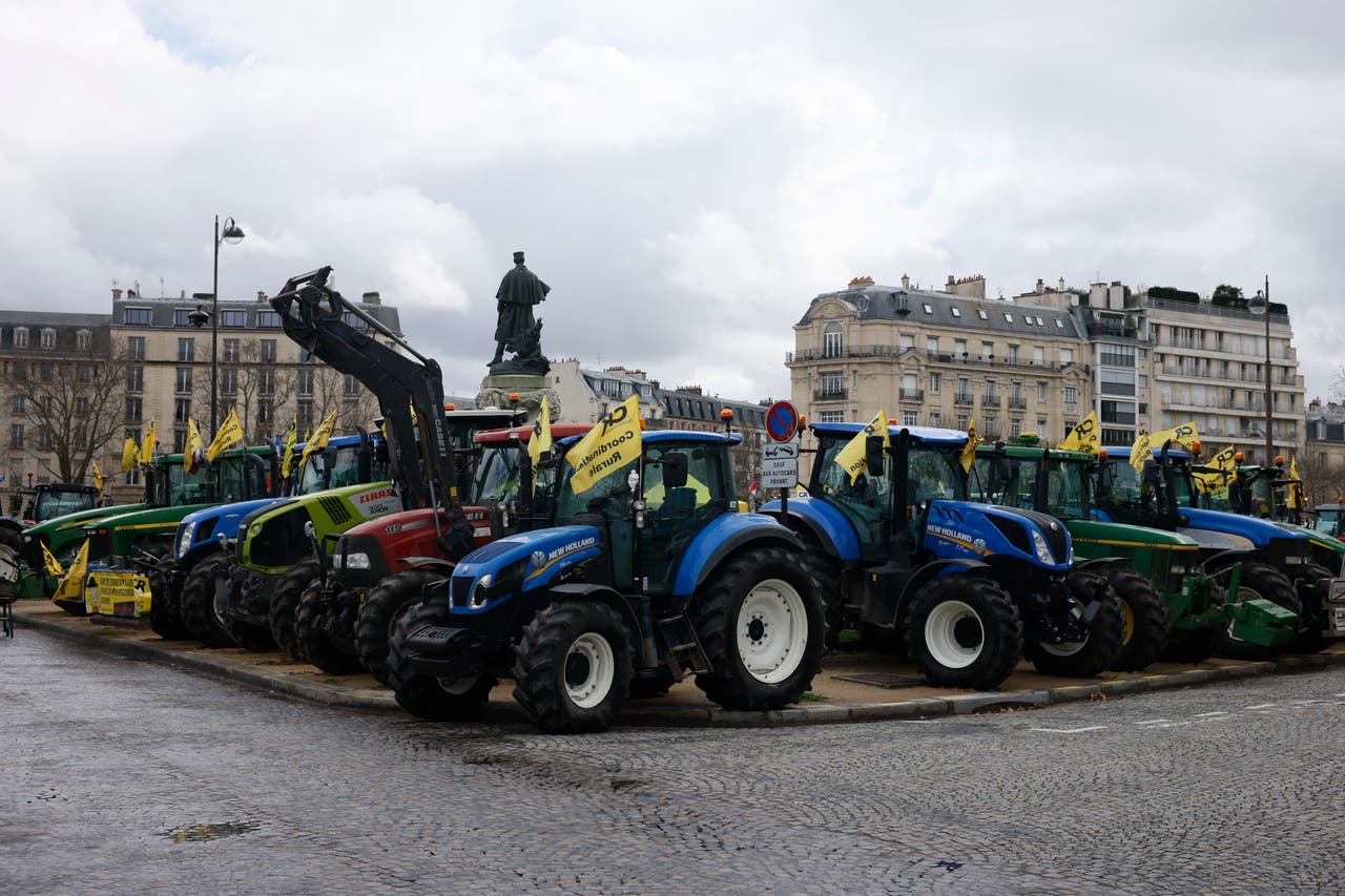 French farmers take tractors back on the streets of Paris in new ...
