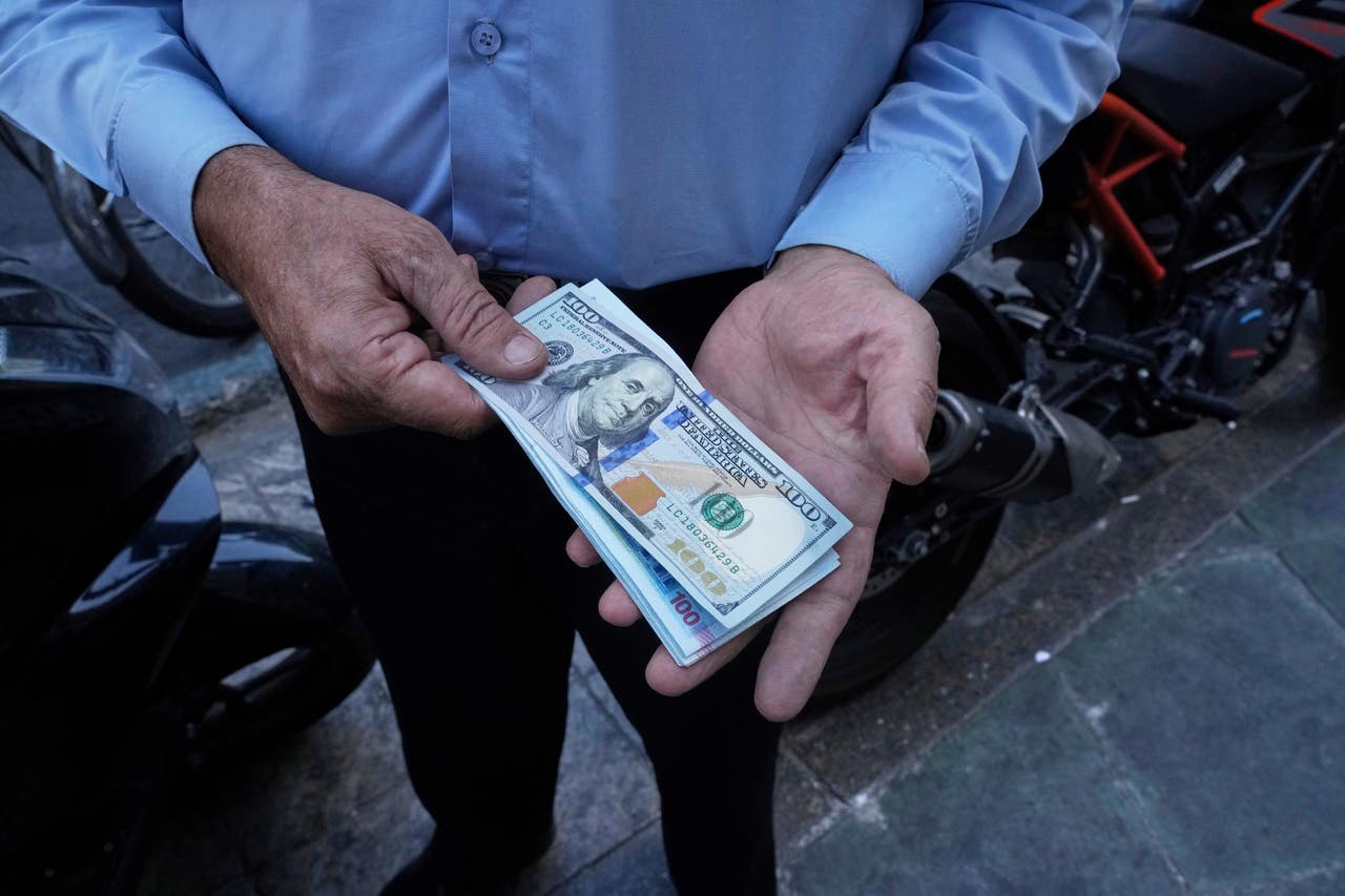 Iran’s currency falls to new low as nuclear sanctions squeeze ailing ...